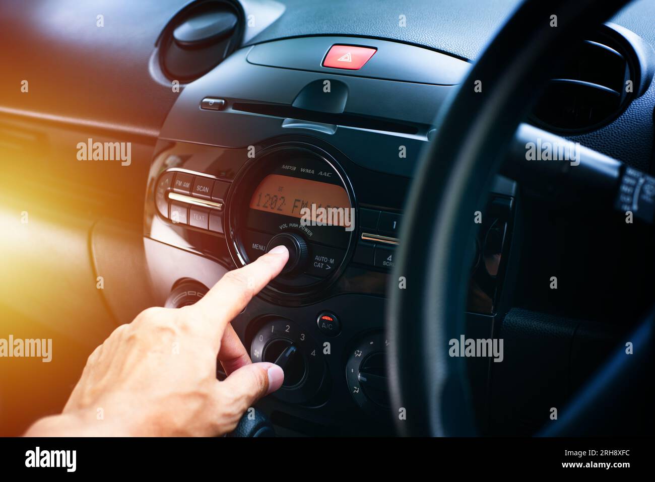 Close up the man's hand adjusting car radio. Car audio system concept ...
