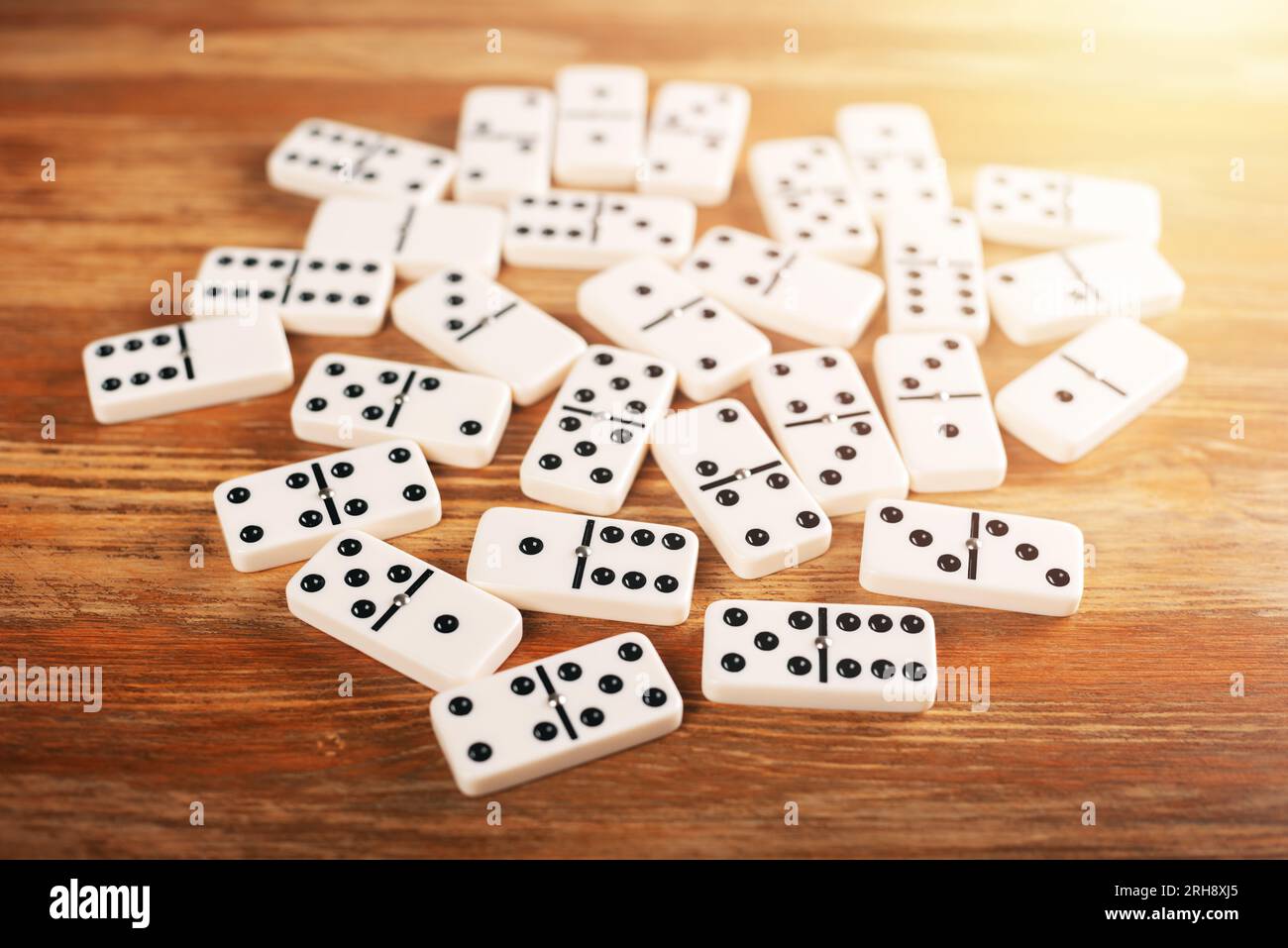 Domino tiles on wooden table. Dominoes is one of the most famous ...