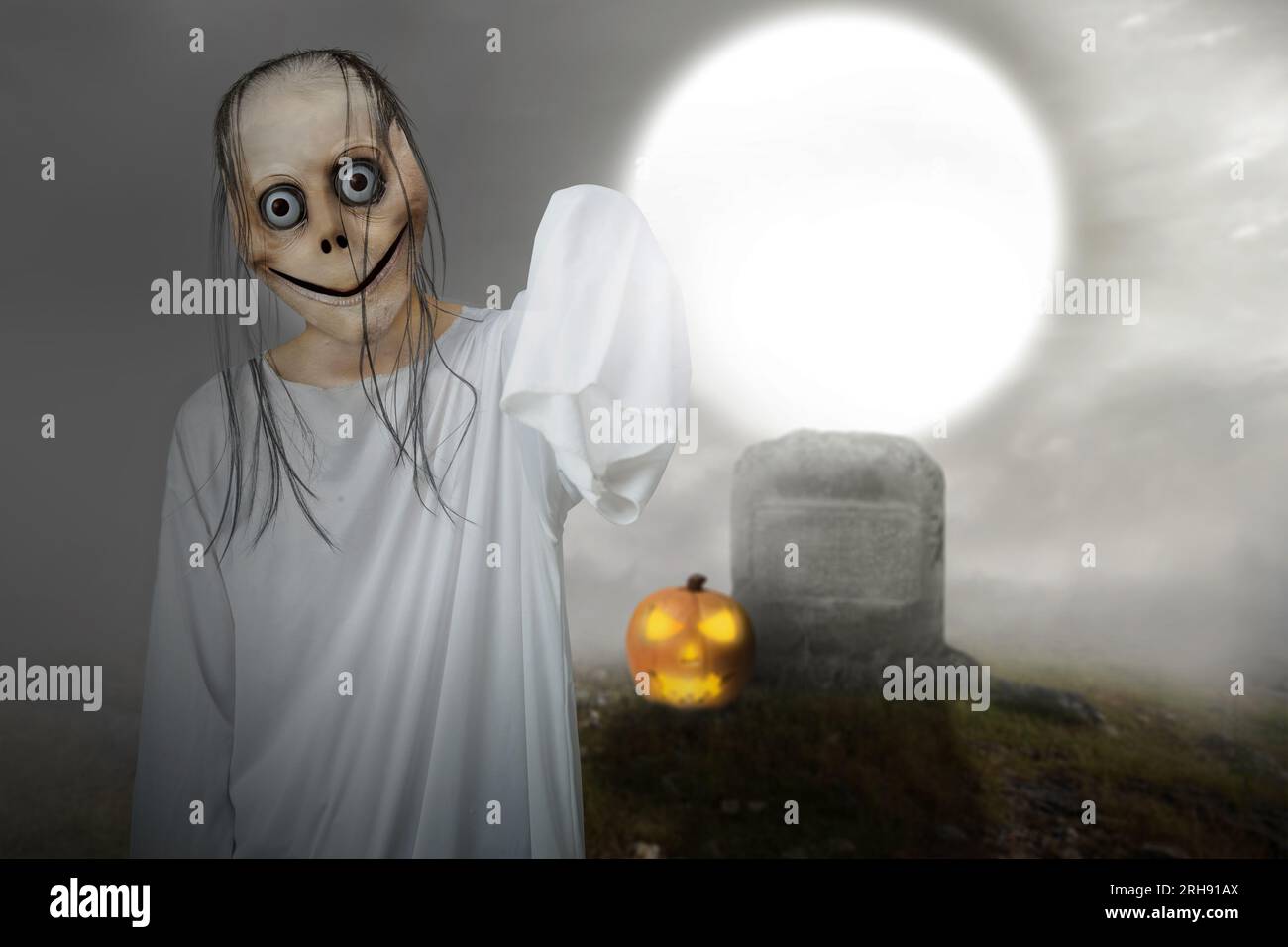 Scary Momo standing in the graveyard with a night scene background ...