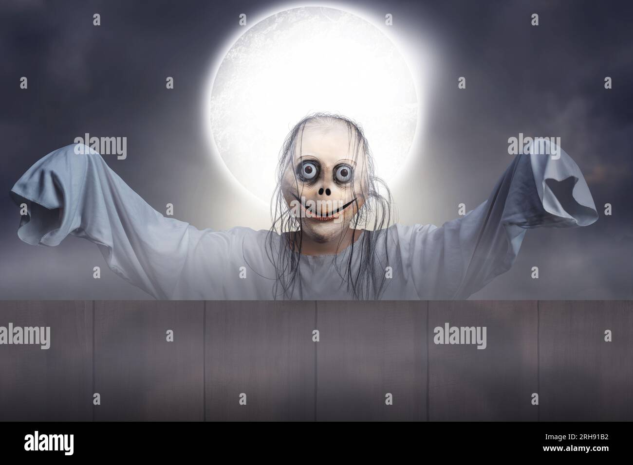 Scary Momo standing behind the wooden fence with a night scene ...