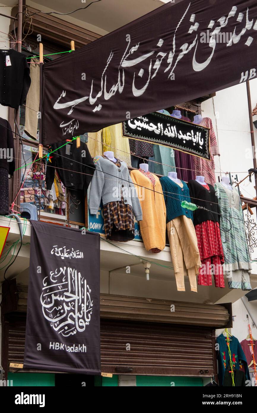 India, Jammu & Kashmir, Kargil old bazaar, Ashura posters on clothes ...