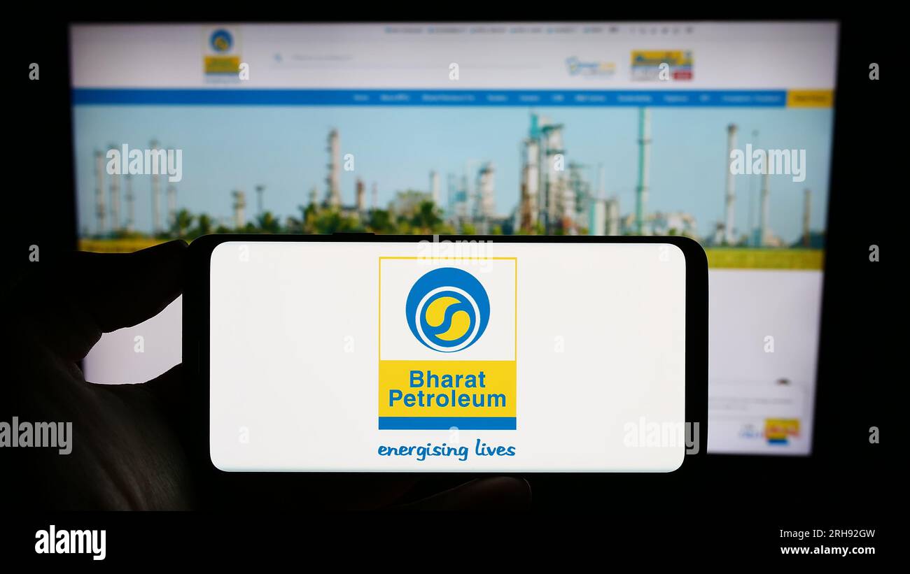 Person holding cellphone with logo of Bharat Petroleum Corporation ...