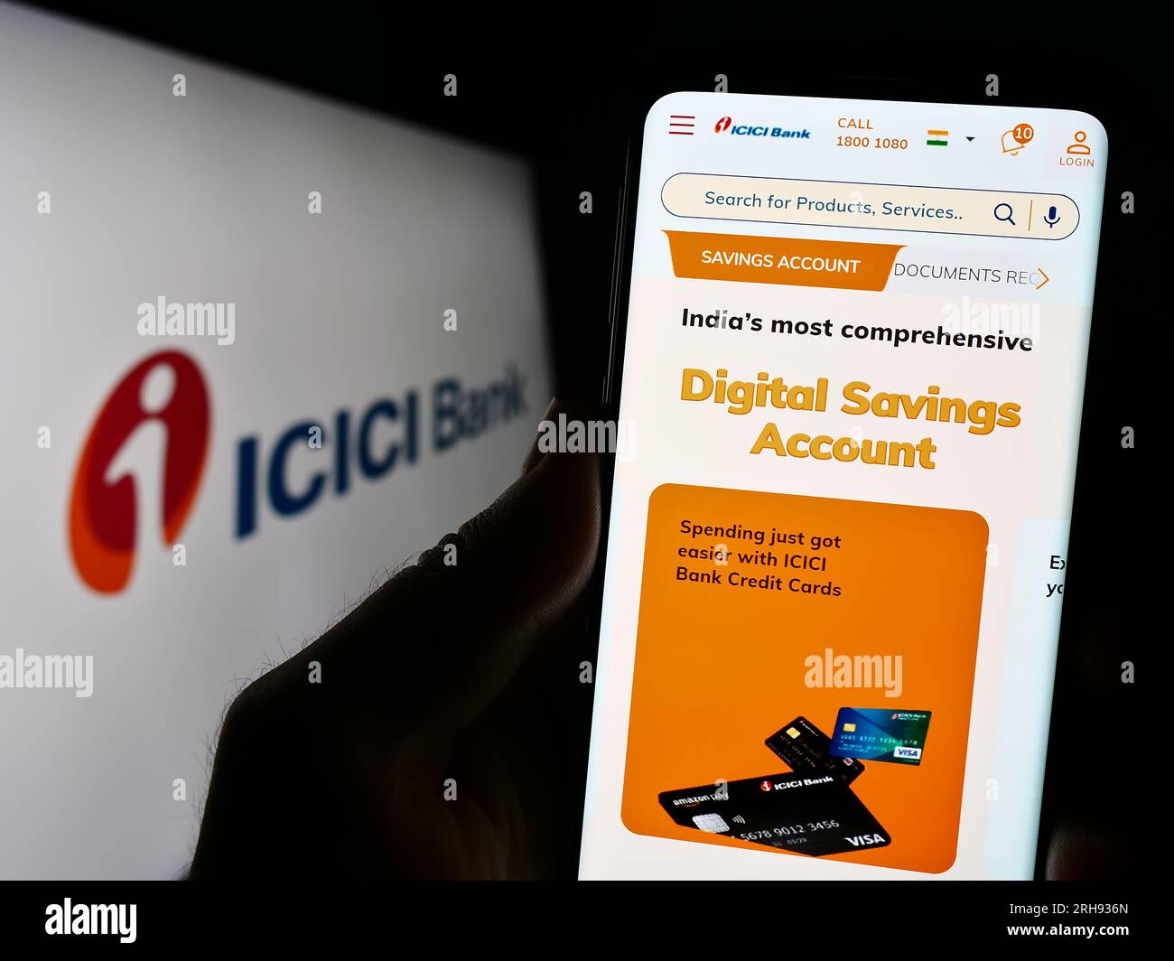 Person holding cellphon with webpage of Indian financial company ICICI ...