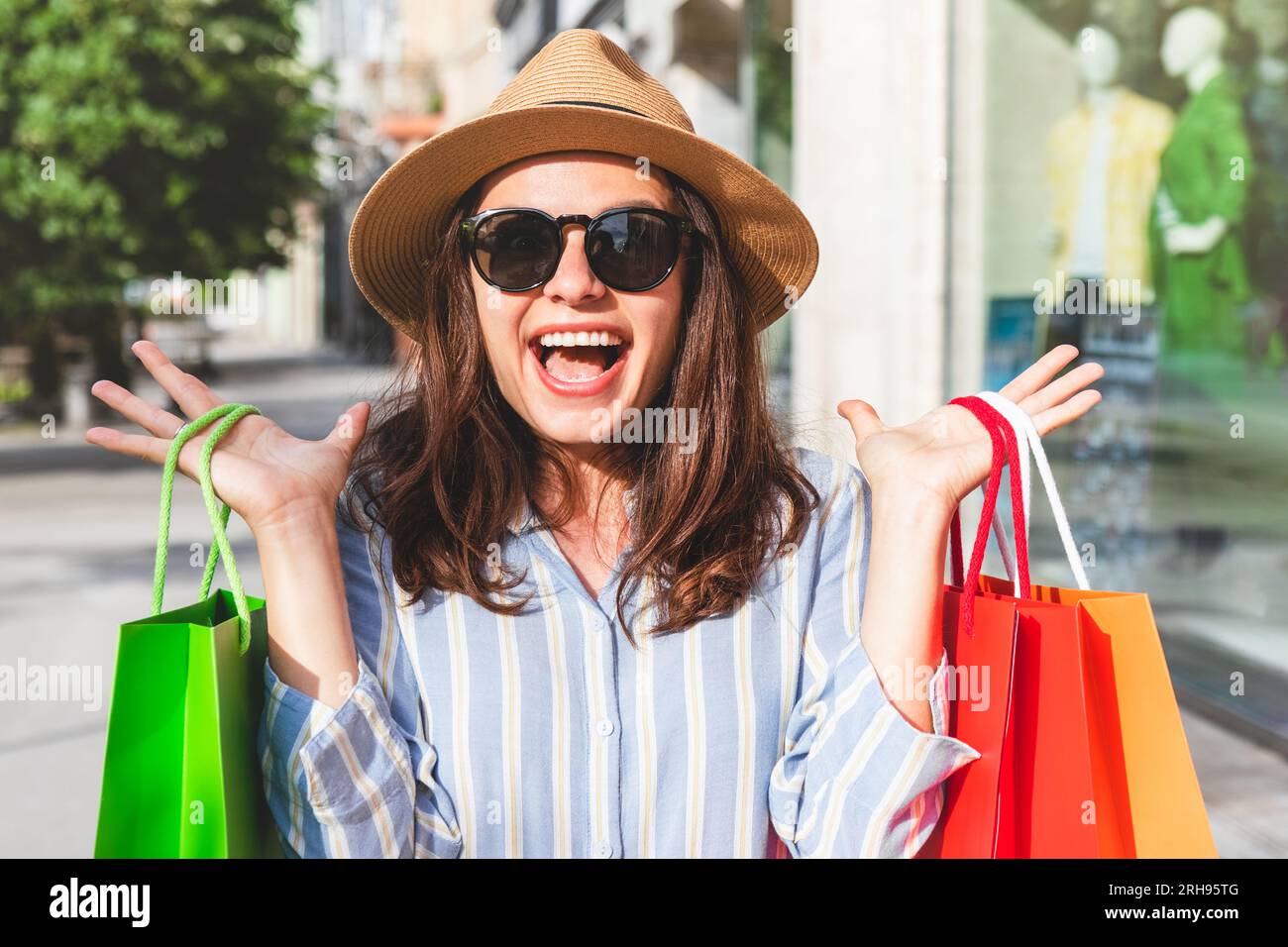 Young woman happy with new purchases, street retail, fashion shopping ...