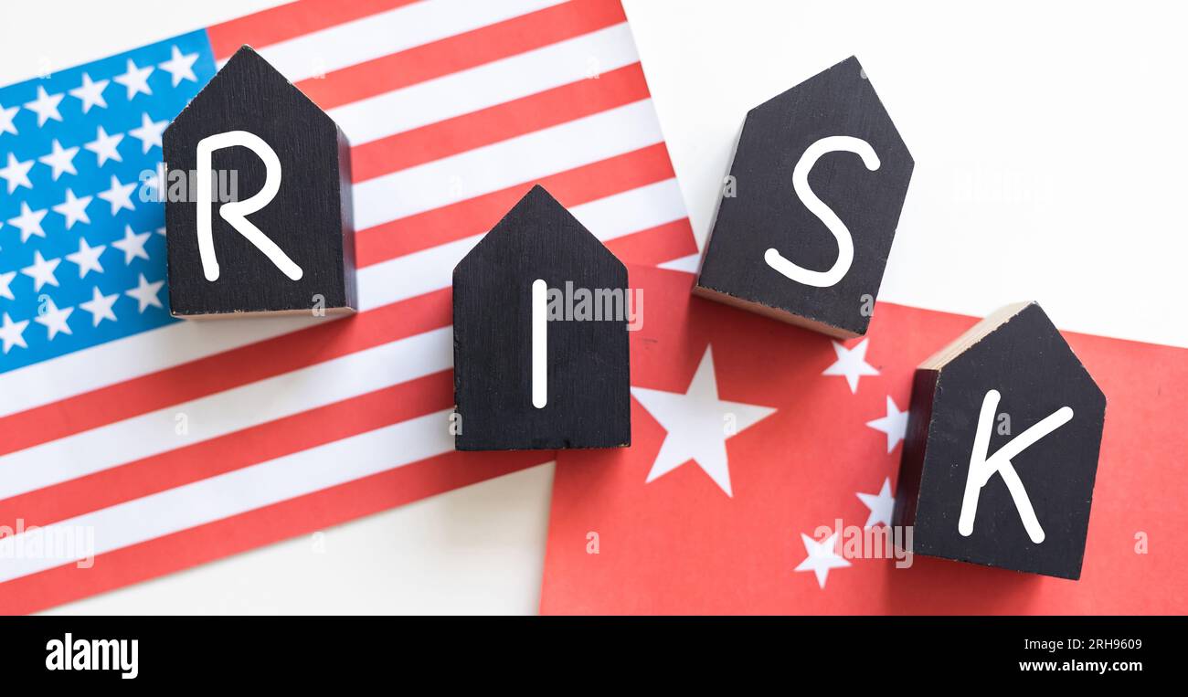 Money bag, blocks with the word Risk and a wooden house on the scales ...