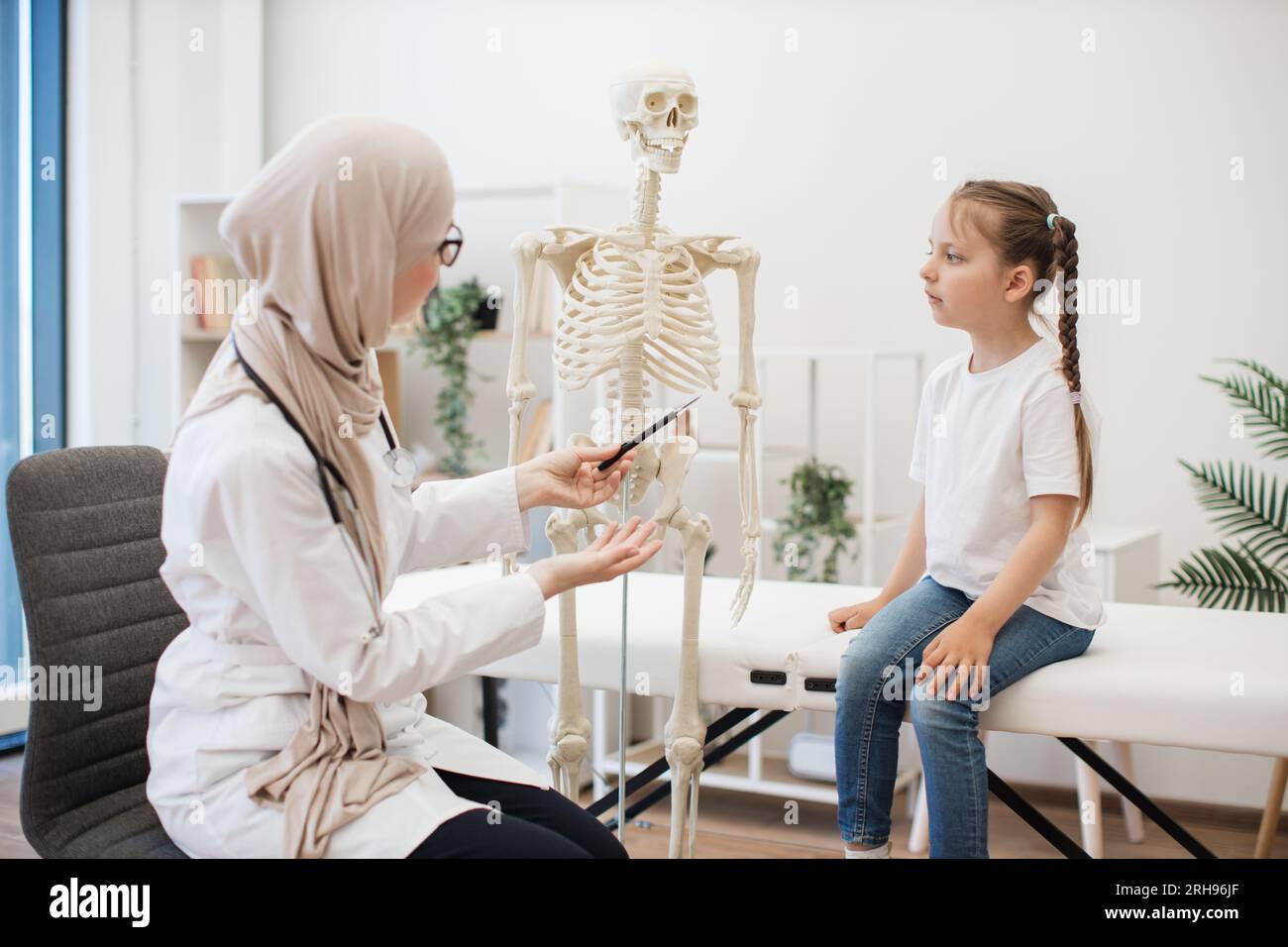 Physician showing ribs on anatomical model to preteen girl Stock Photo ...