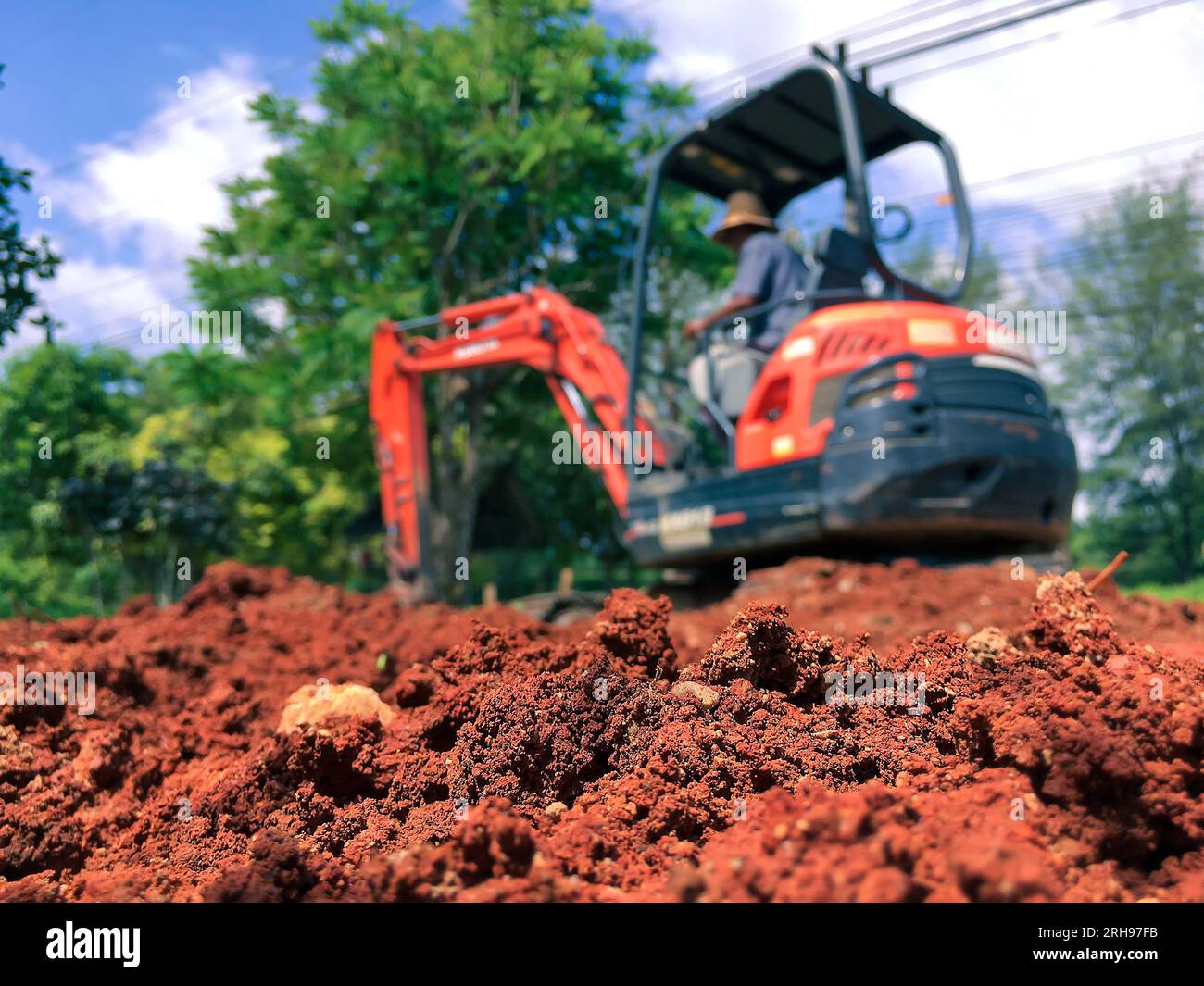 Soil close up blurred backhoe to renovate the site in preparation for ...