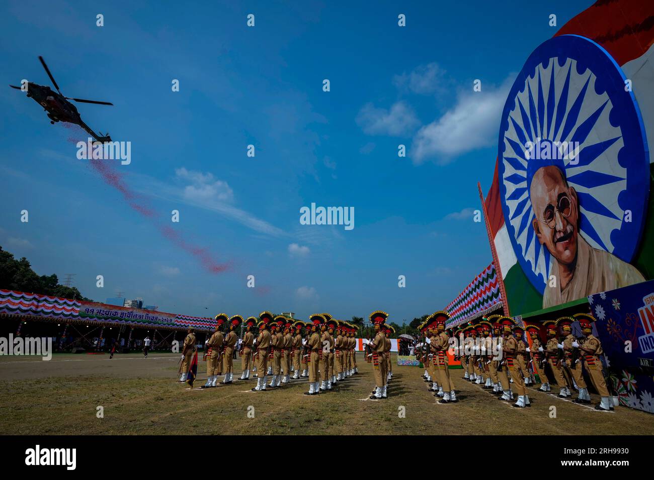 An Indian Air Force helicopter showers flower petals as Assam Police ...
