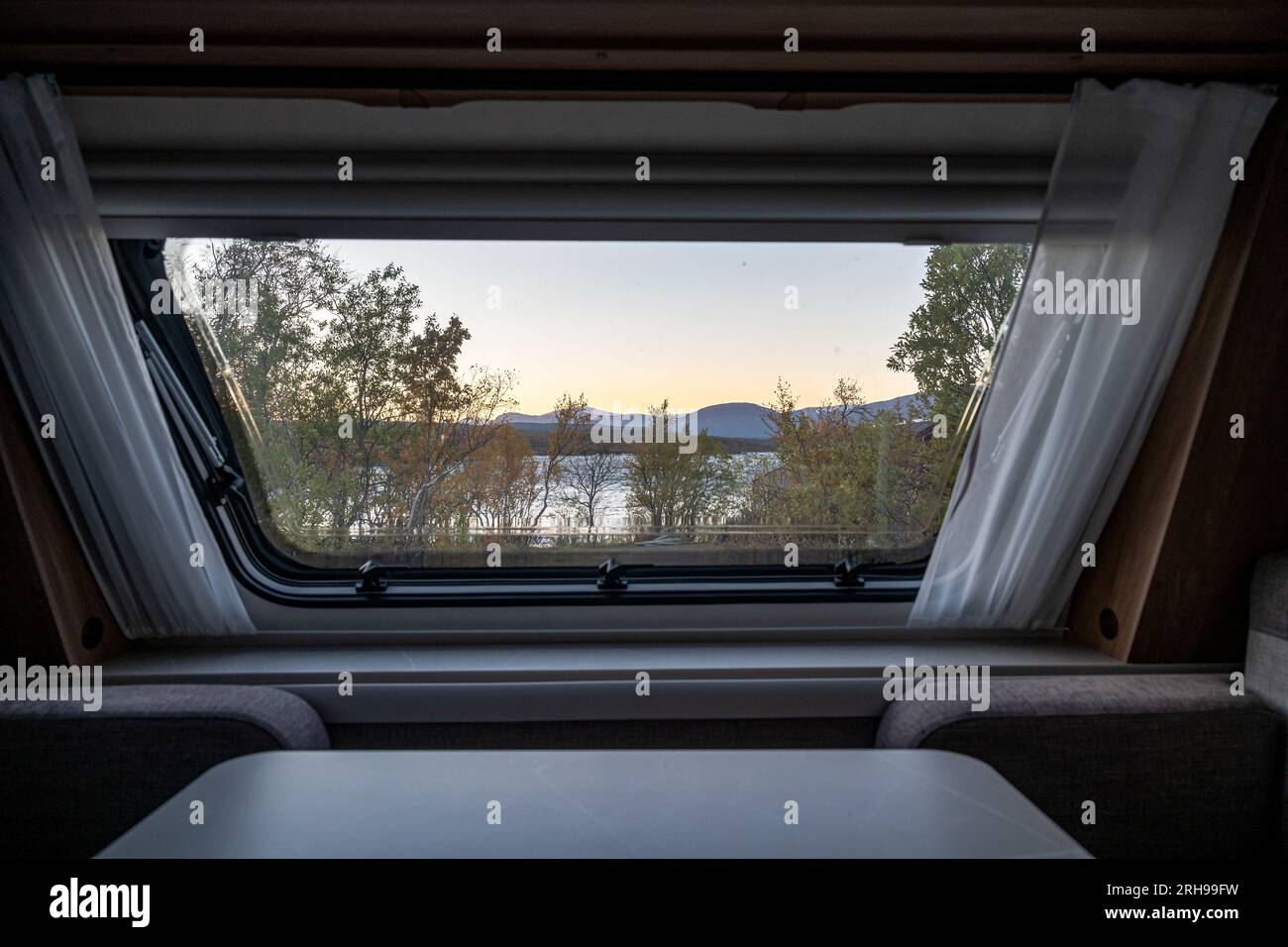 Sunset Autumn season in Abisko through a caravan window with Lake ...