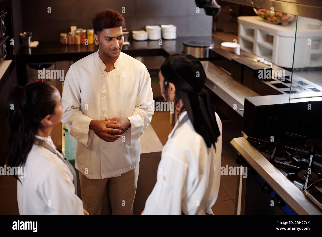 Chef discussing new menu with his team in the beginning of shift Stock ...