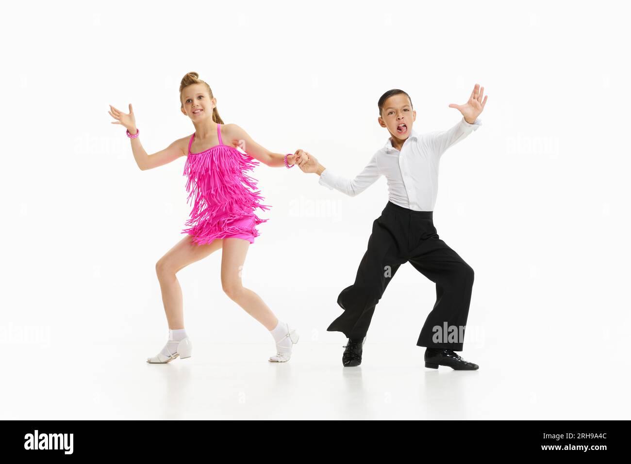 Little children, beautiful boy and girl in stage costumes dancing retro ...