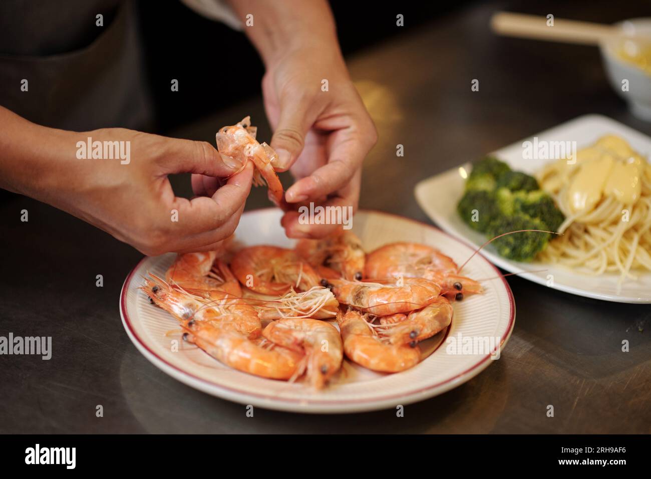 Hands peeling shrimp hi-res stock photography and images - Alamy