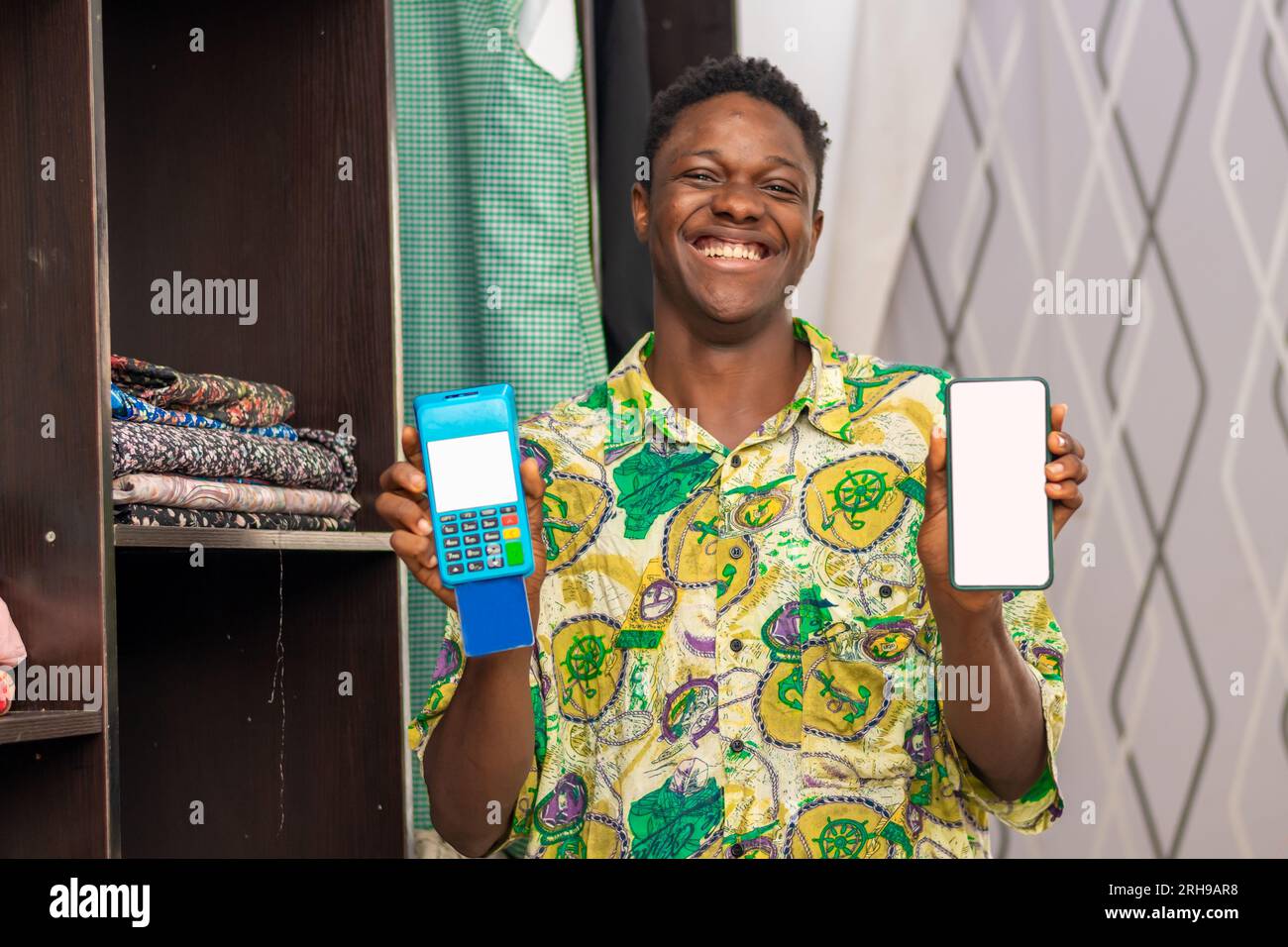 photo of a cheerful black businessman smiling while holding pos ...