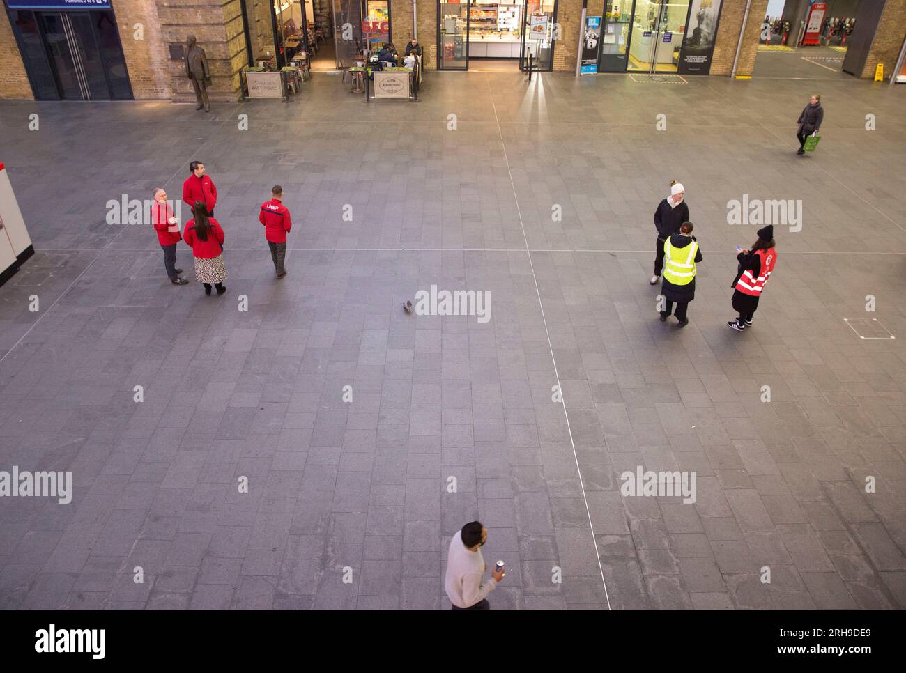 Members of the staff stand at a quiet King’s Cross Station in London ...