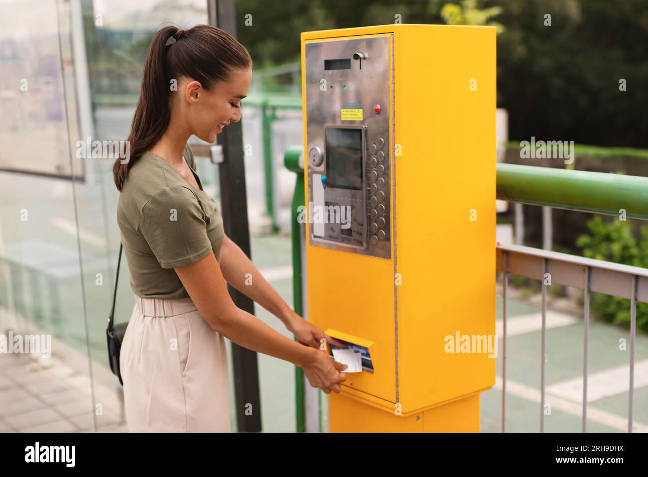 Cheerful Lady Passenger Using Ticket Vending Machine At Outdoor Station ...