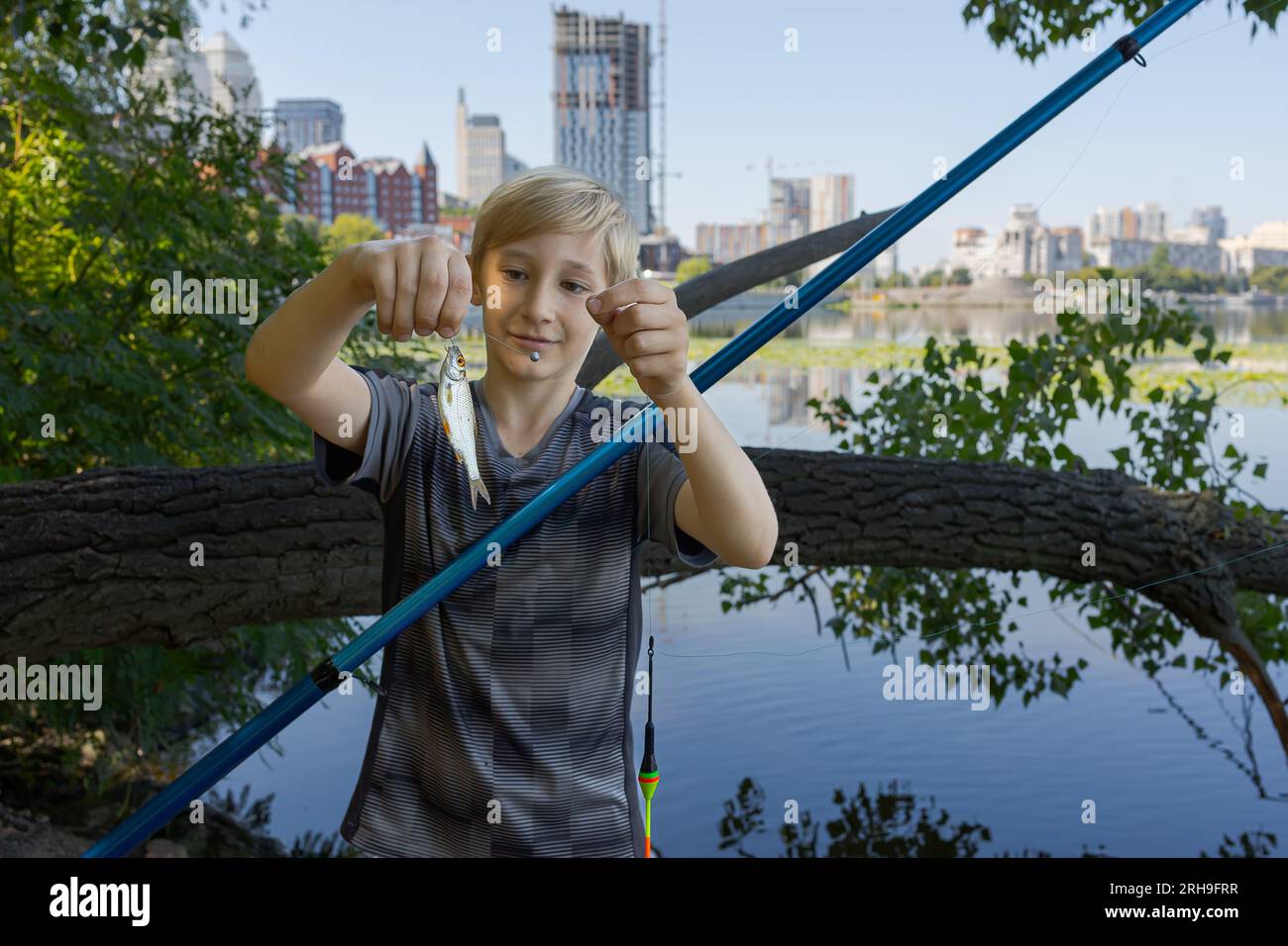The boy shows Fishy's catch hanging on his hook. Sport fishing on the ...