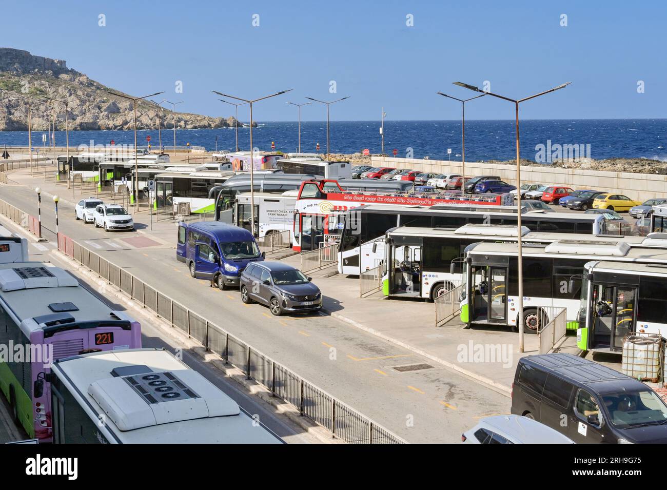 Mellieha, Malta - 5 August 2023: Buses, cars and coaches parked in the ...