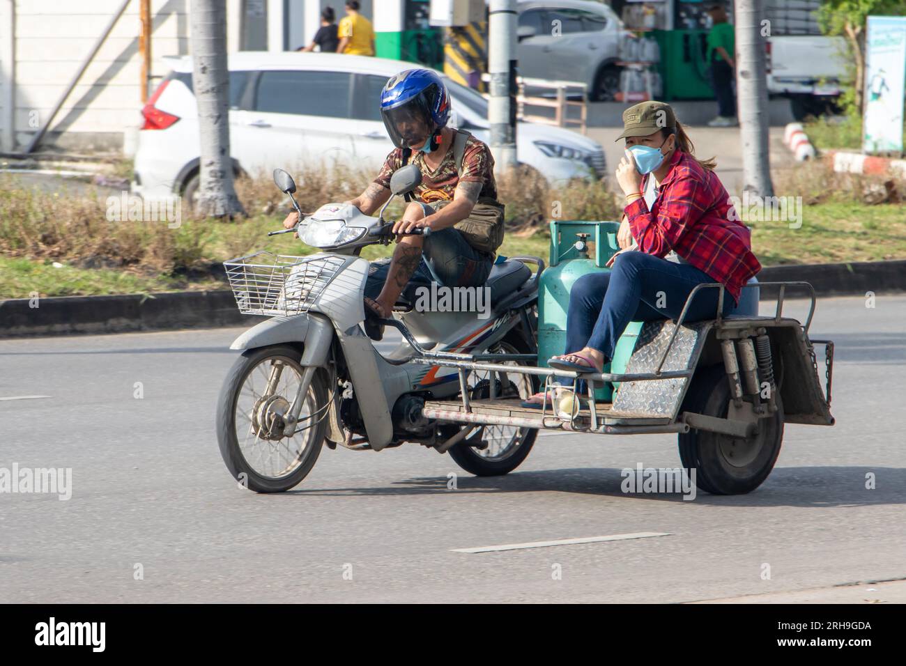 RATCHABURI, THAILAND, OCT 18 2022, A pair ride a motorcycle with a ...
