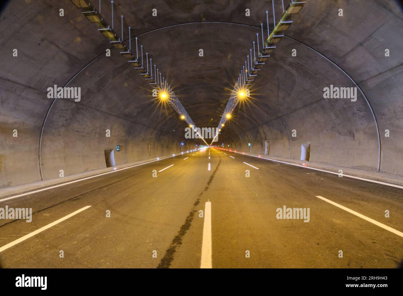 Modern new tunnel on a highway illuminated with lights and traffic ...