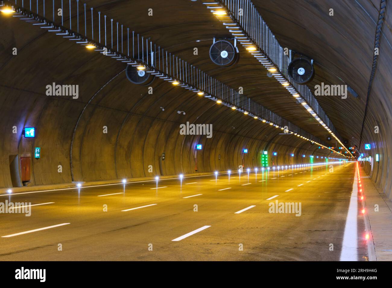 Modern new tunnel on a highway illuminated with lights and traffic ...