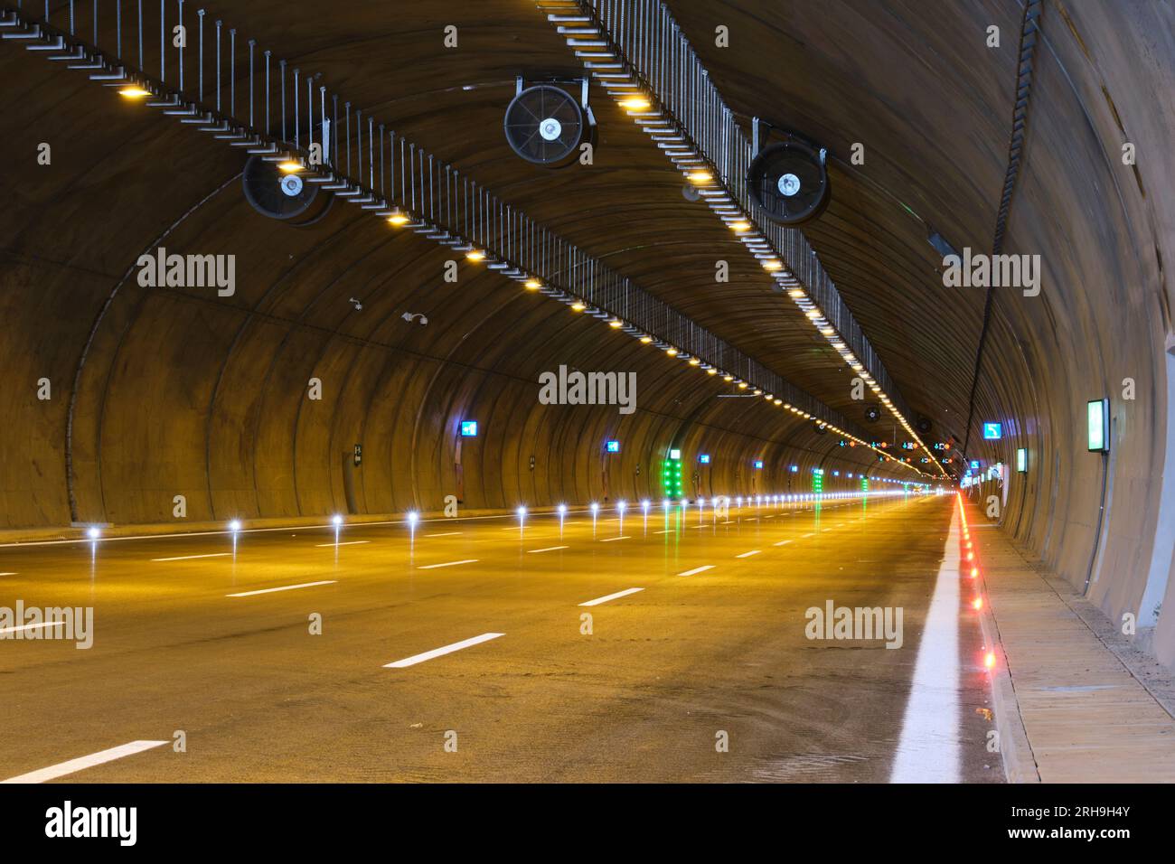 Modern new tunnel on a highway illuminated with lights and traffic ...
