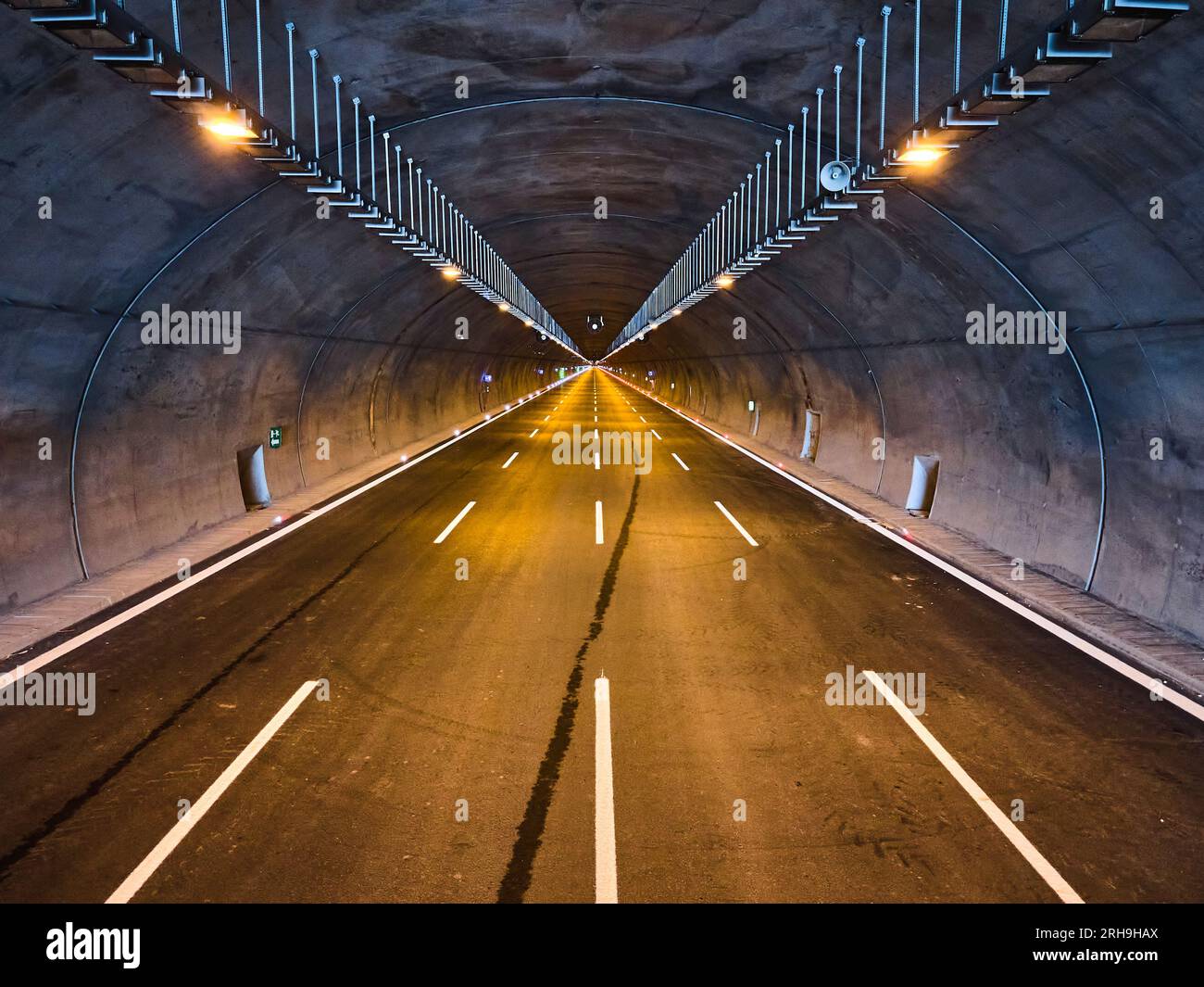 Modern new tunnel on a highway illuminated with lights and traffic ...