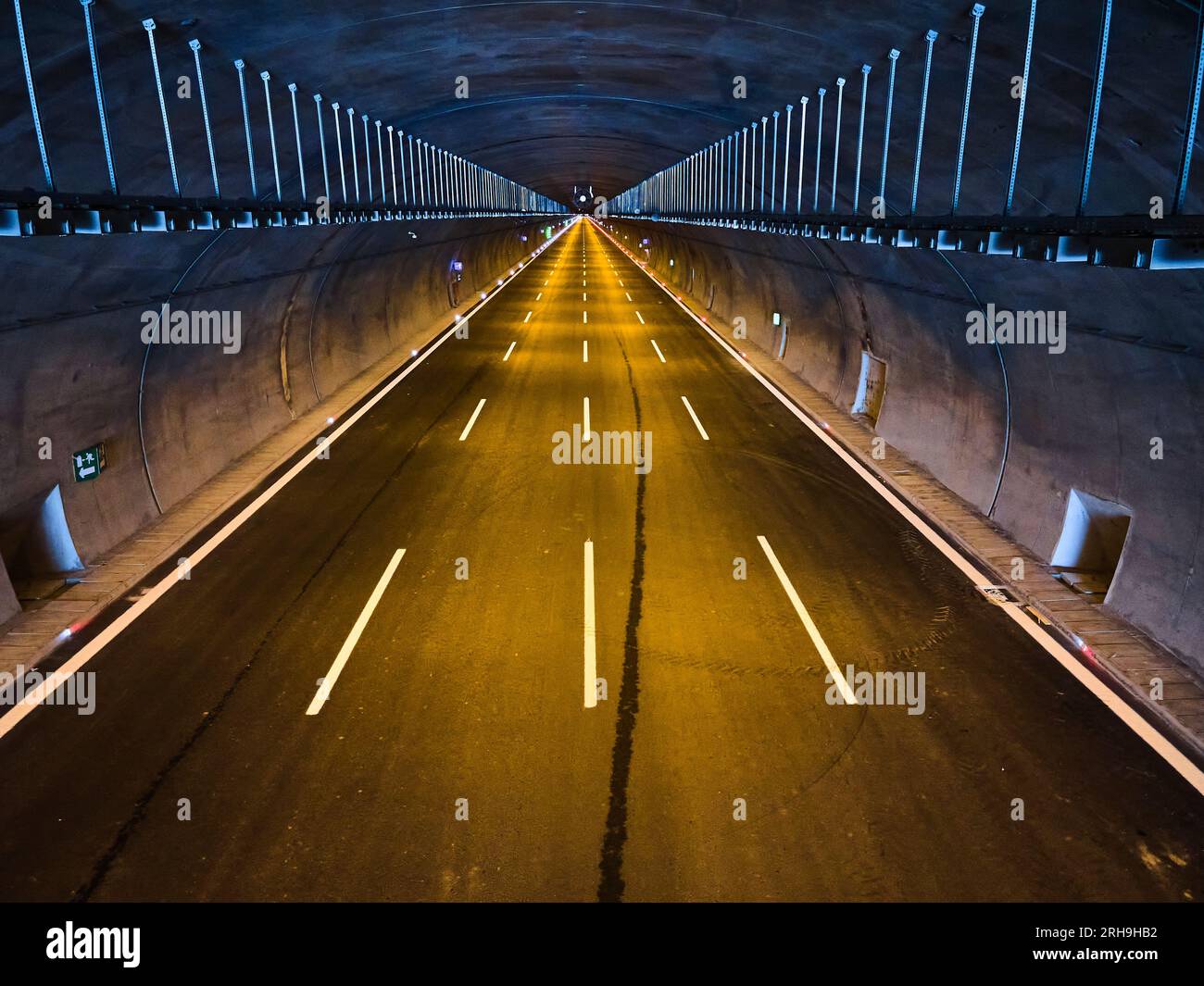 Modern new tunnel on a highway illuminated with lights and traffic ...
