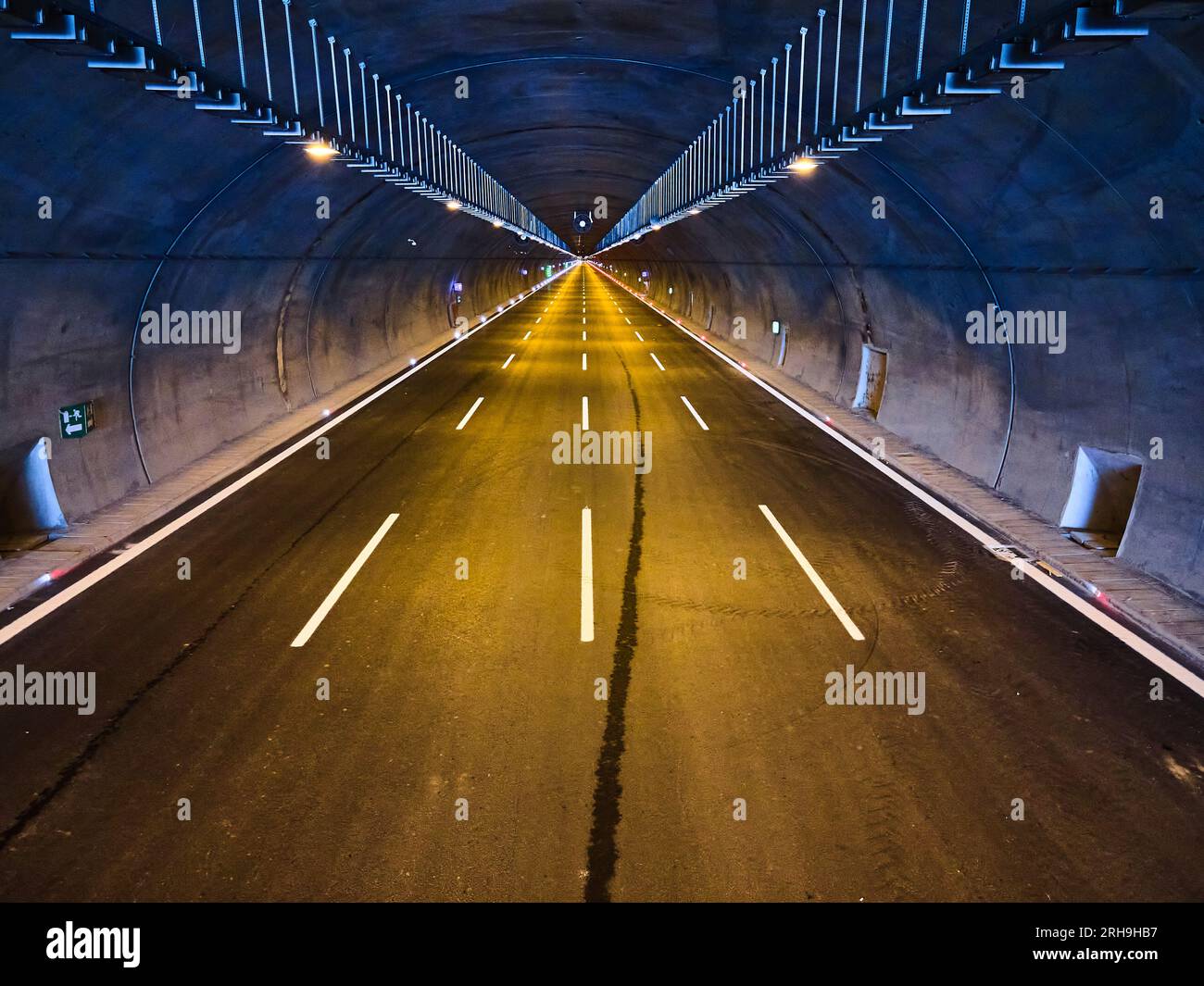 Modern new tunnel on a highway illuminated with lights and traffic ...