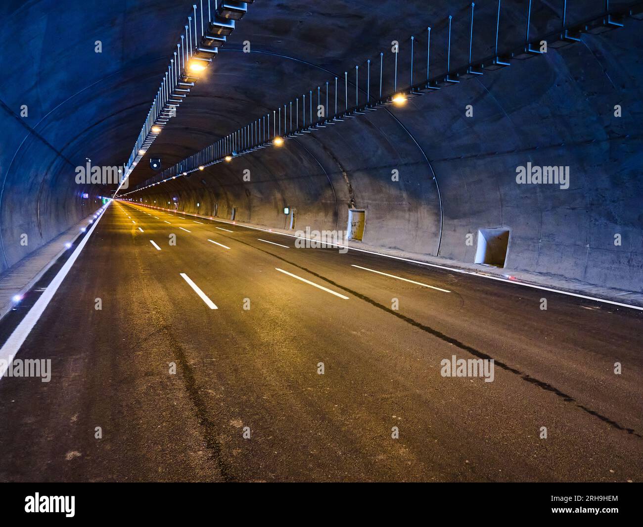 Modern new tunnel on a highway illuminated with lights and traffic ...
