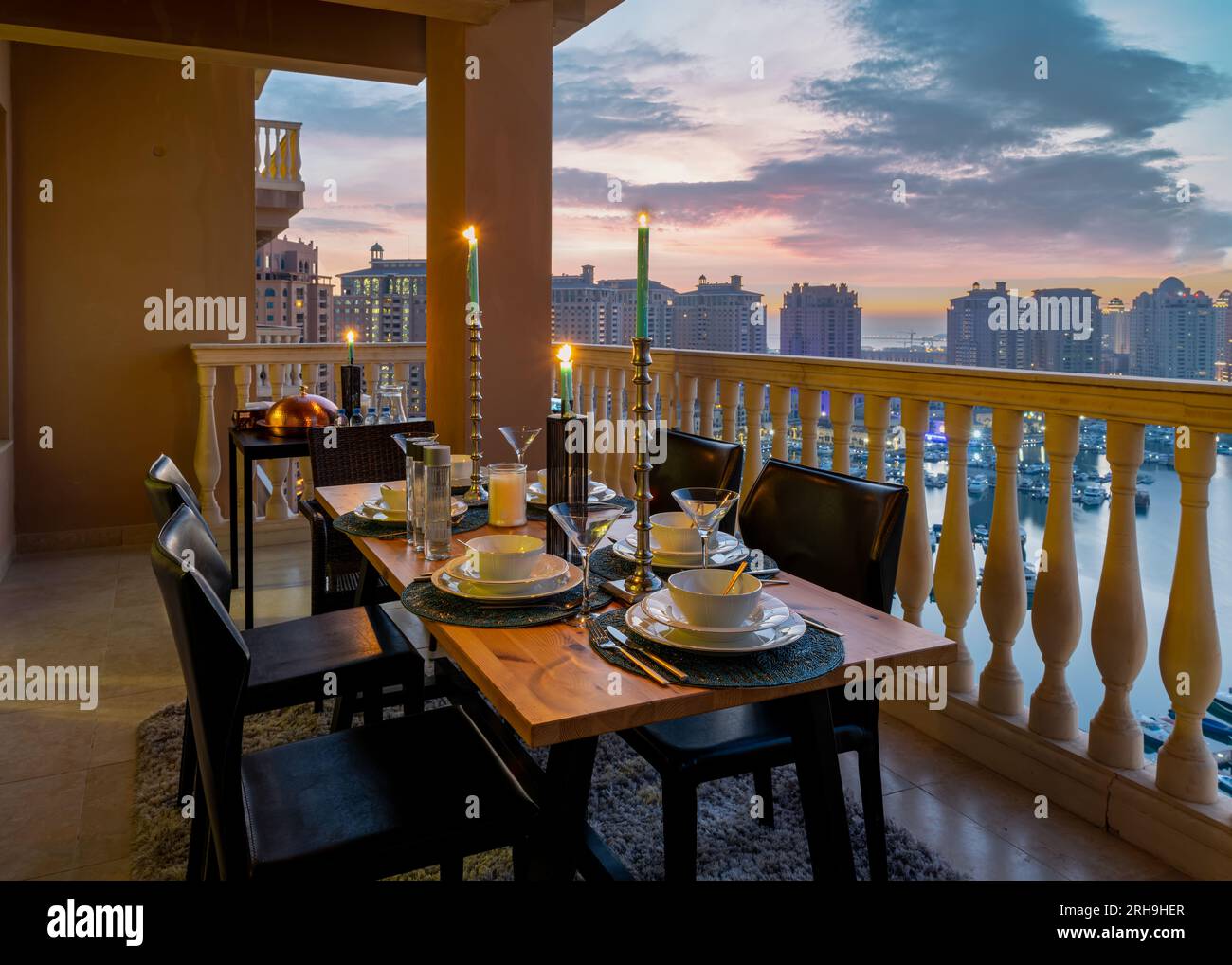 Dinner table at rooftop with sunset view at pearl Qatar. view of Peral ...