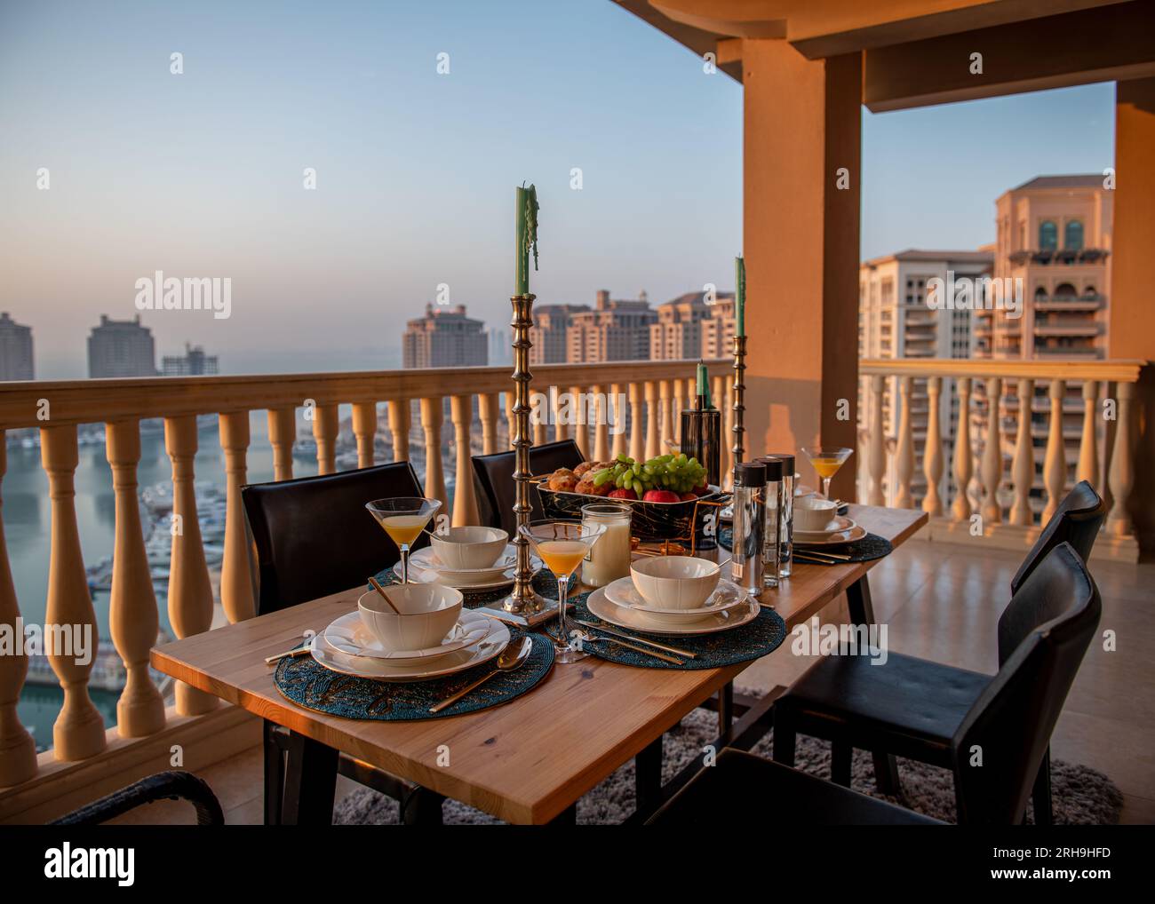 Dinner table at rooftop with sunset view at pearl Qatar. view of Peral ...