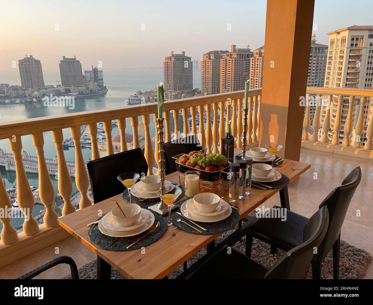 Dinner table at rooftop with sunset view at pearl Qatar. view of Peral ...