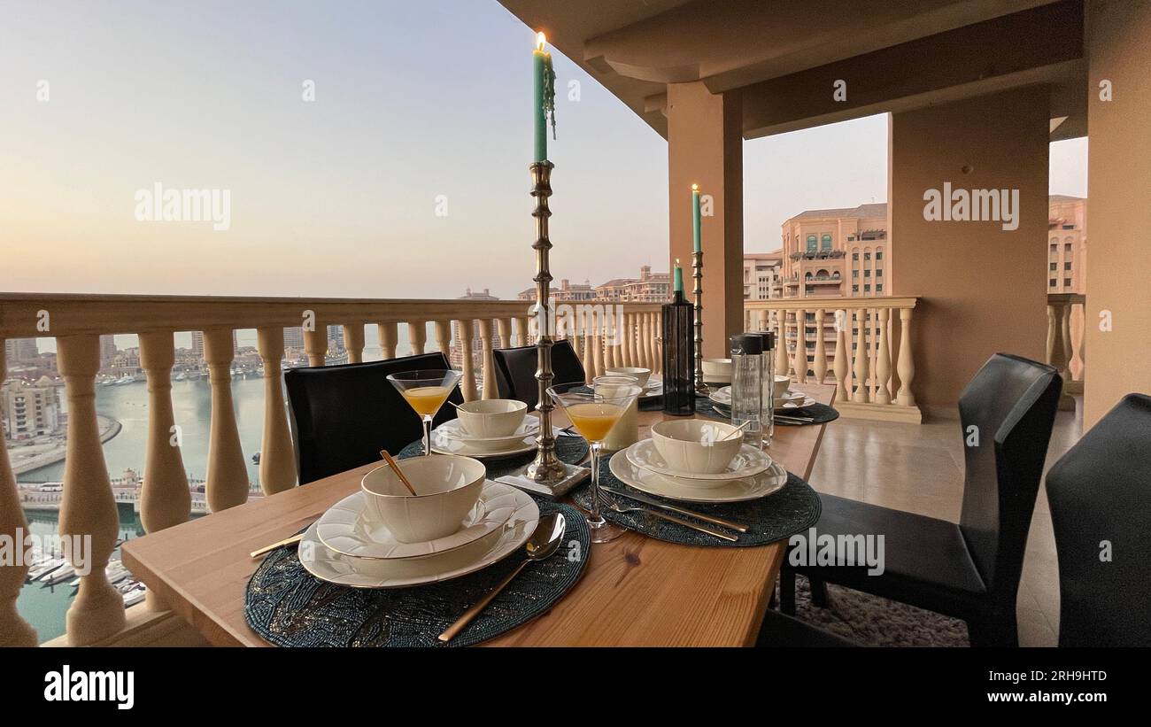 Dinner table at rooftop with sunset view at pearl Qatar. view of Peral ...
