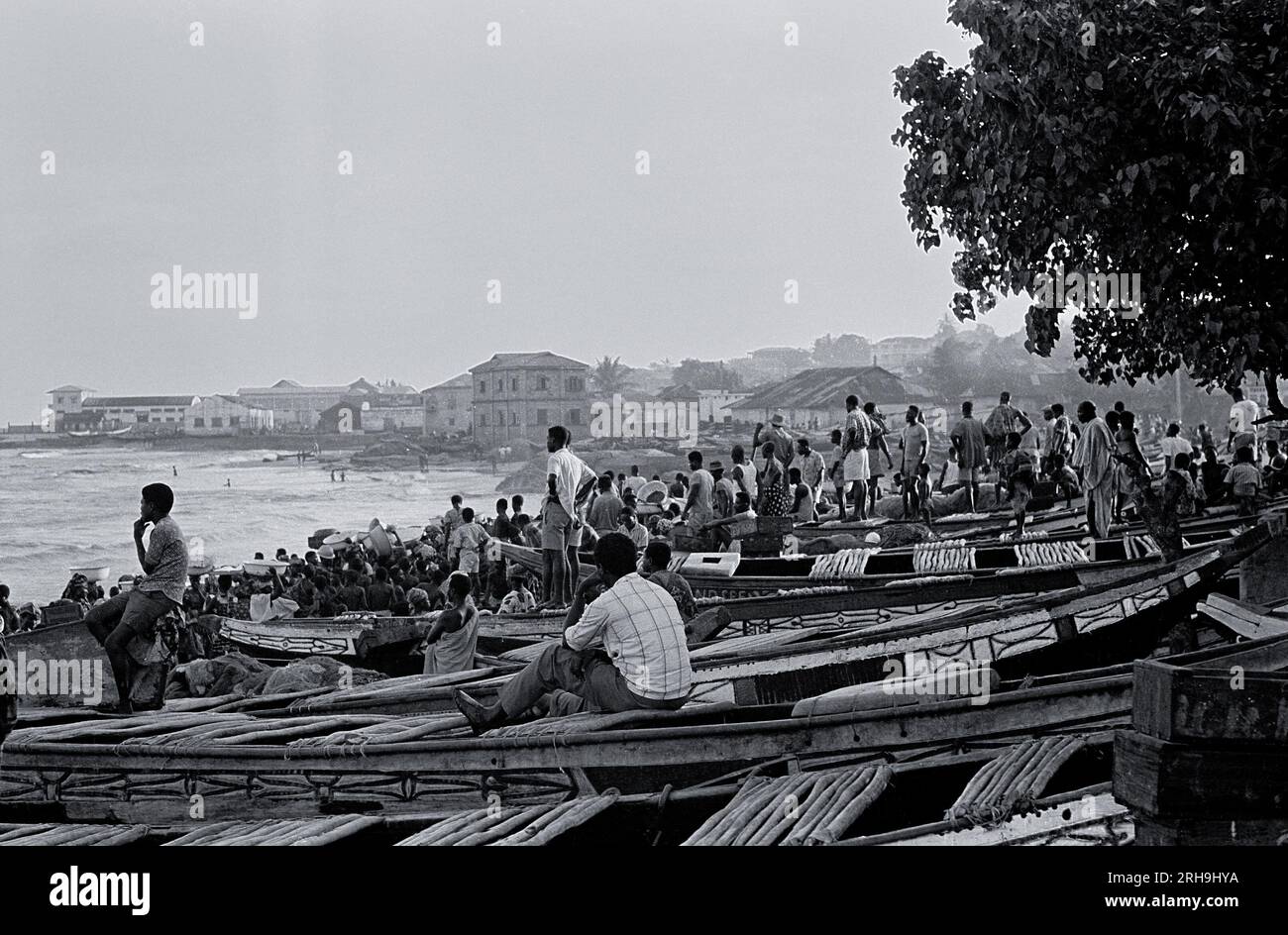 Crowd at the fishing quarter, Winneba, Ghana, awaiting the return of ...