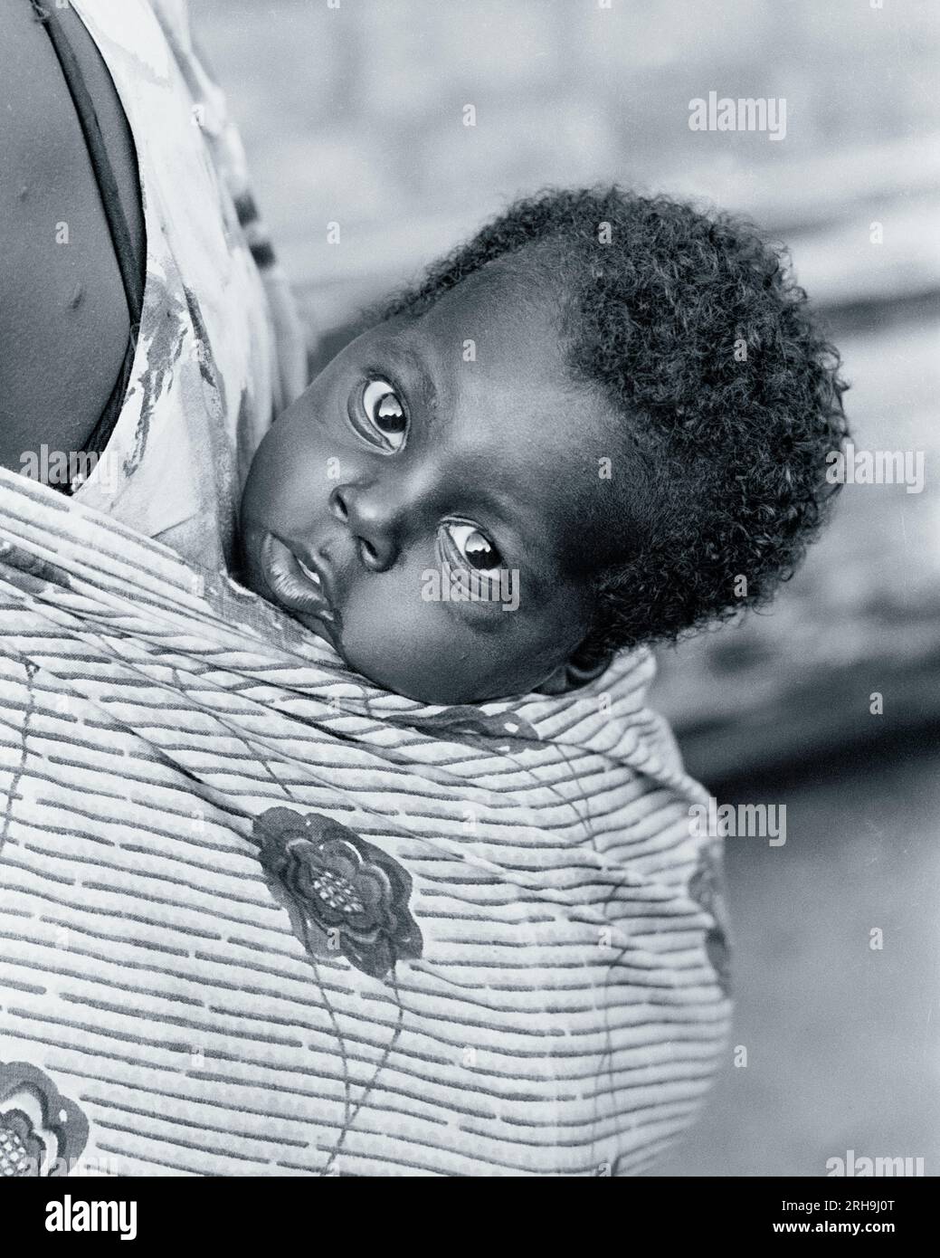 Baby carried on the Ghanaian mother's back in a cloth wrapped around ...