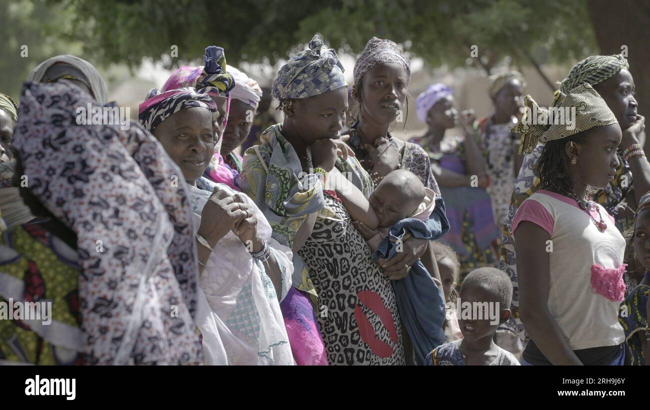 African mom carrying her child on her back. showing the beautiful ...