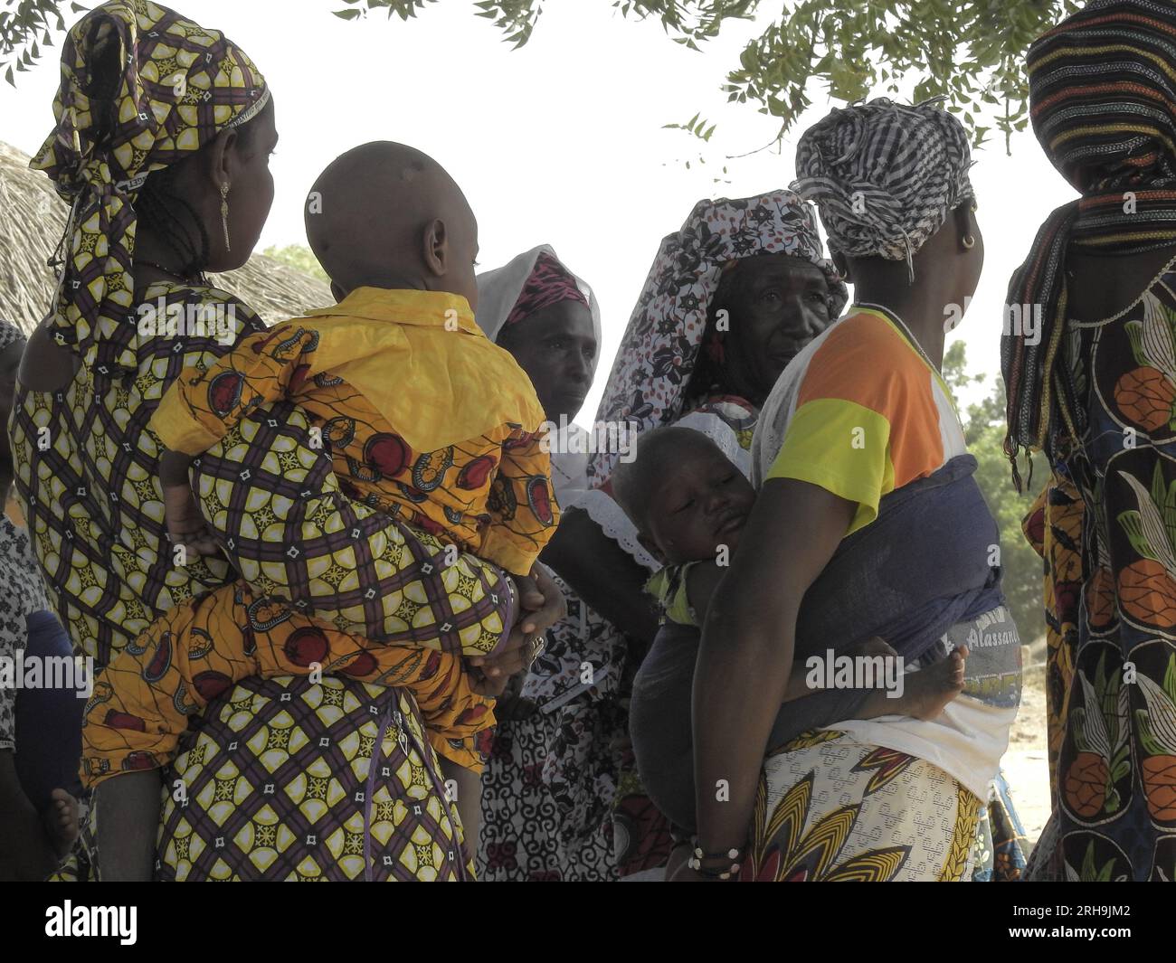 African mom carrying her child on her back. showing the beautiful ...