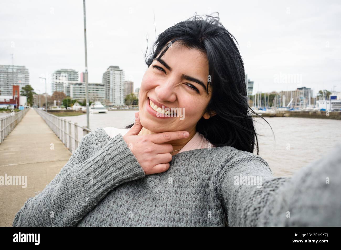young venezuelan latin woman, standing on pier over river in buenos ...