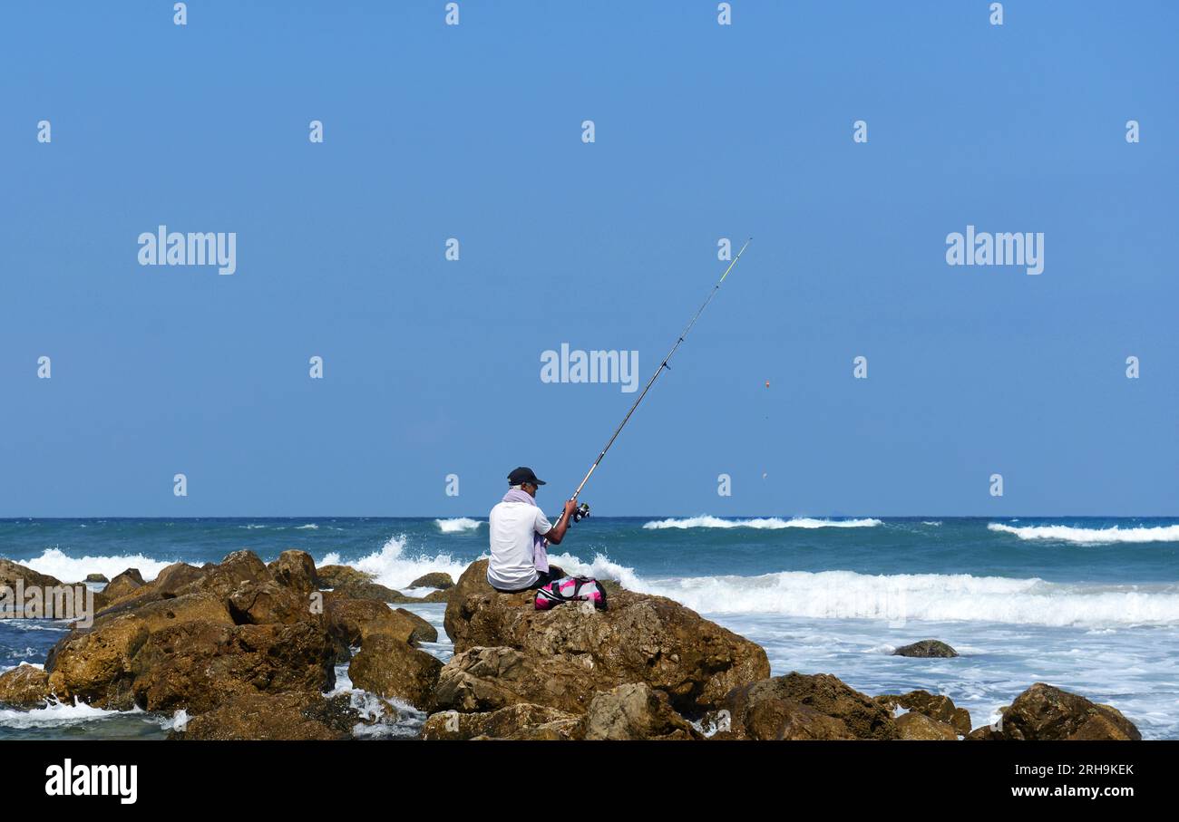 An Israeli man fishing at the beautiful beach in Bat Yam, Israel Stock ...