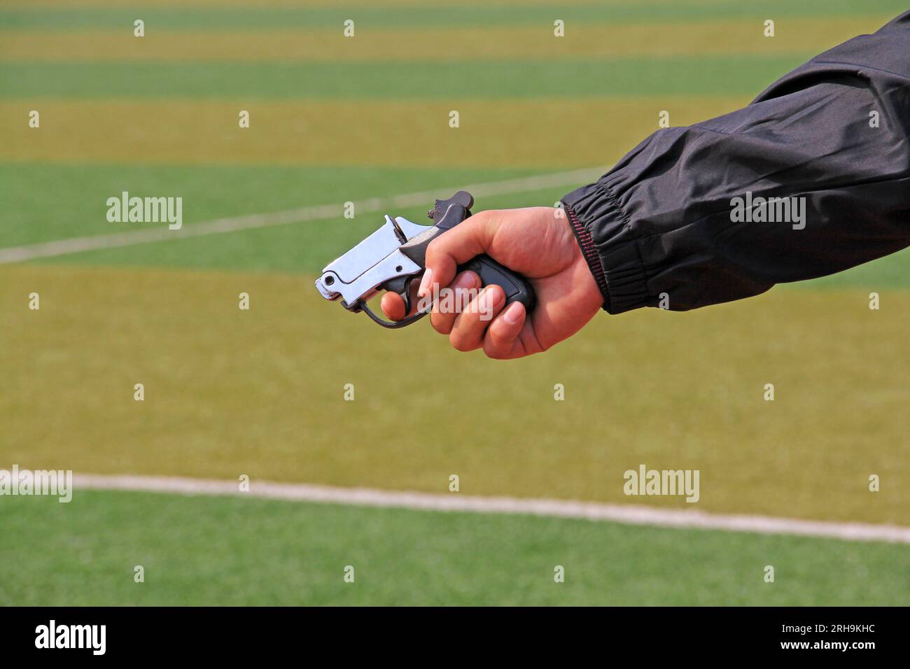 hand holding starting gun, closeup of photo Stock Photo - Alamy