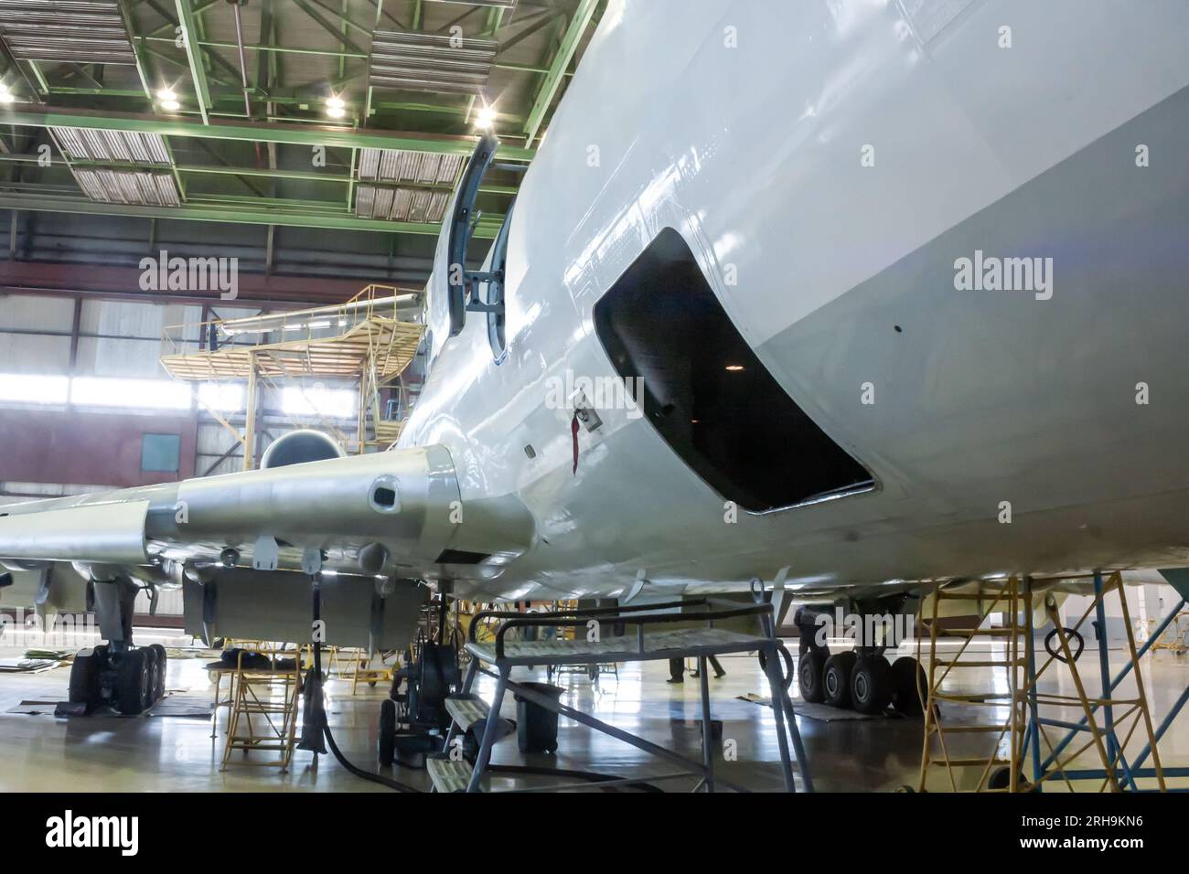 White passenger aircraft in the hangar. Airplane under maintenance ...