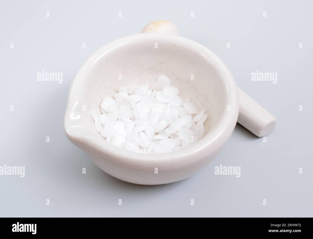 Potassium hydroxide or caustic potash on light grey background Stock ...