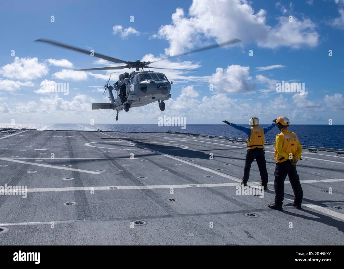 Sailors signal an MH-60S Sea Hawk helicopter, Pacific Ocean on July 20 ...
