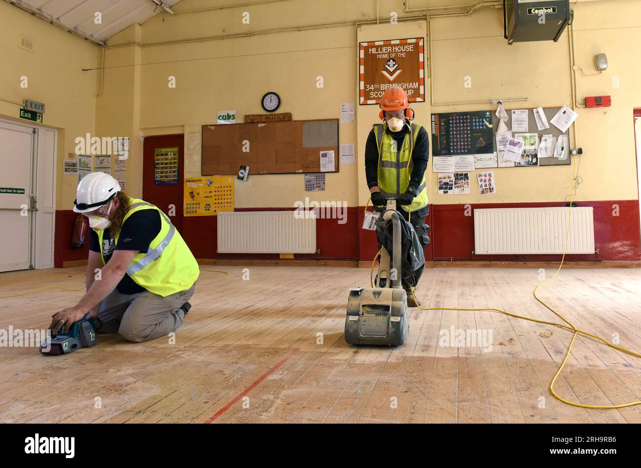 Construction workers sanding wooden floor Stock Photo - Alamy