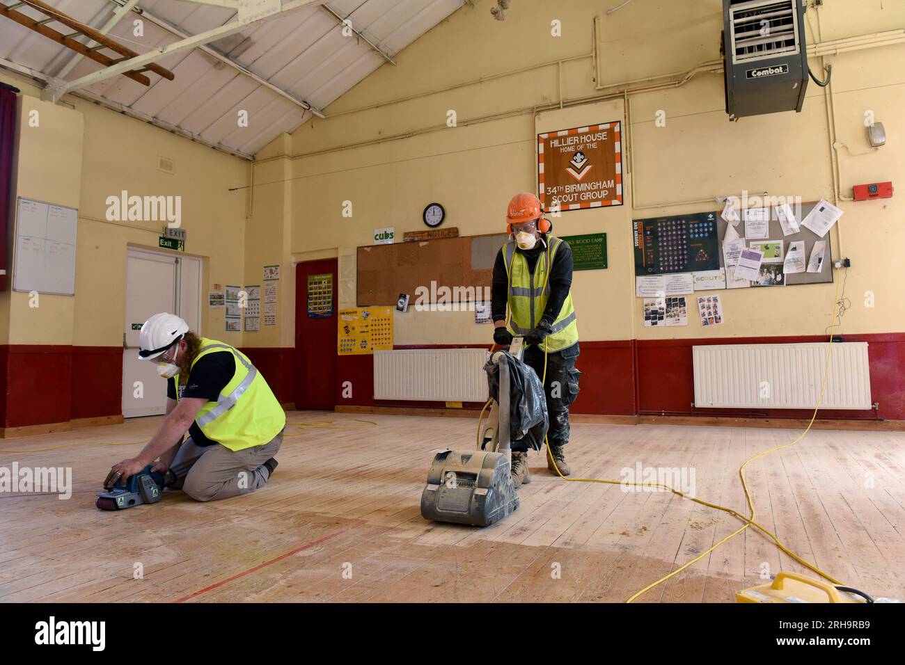Construction workers sanding wooden floor Stock Photo - Alamy