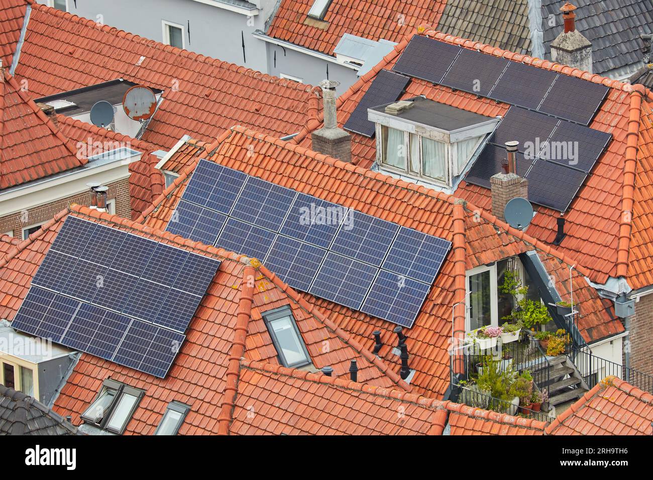 Solar panels attached to the roofs of ancient houses in the city center ...