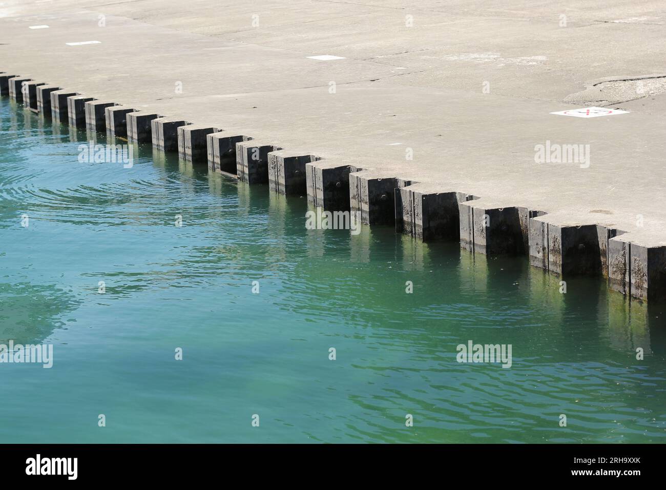 Minimalist view of a corrugated steel retaining wall creating a pier ...