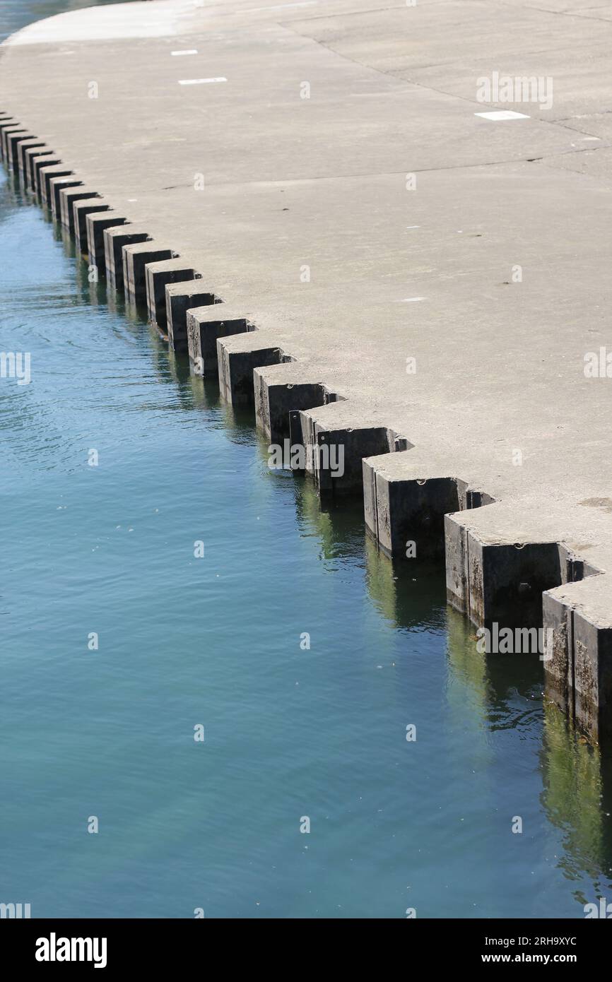 Minimalist view of a corrugated steel retaining wall creating a pier ...