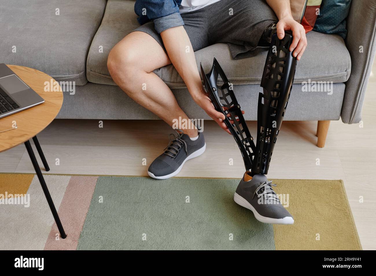 Top view closeup of unrecognizable man putting on prosthetic leg at ...