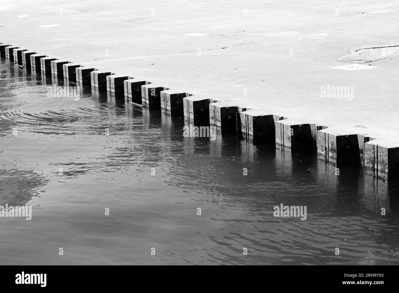 Minimalist view of a corrugated steel retaining wall creating a pier ...